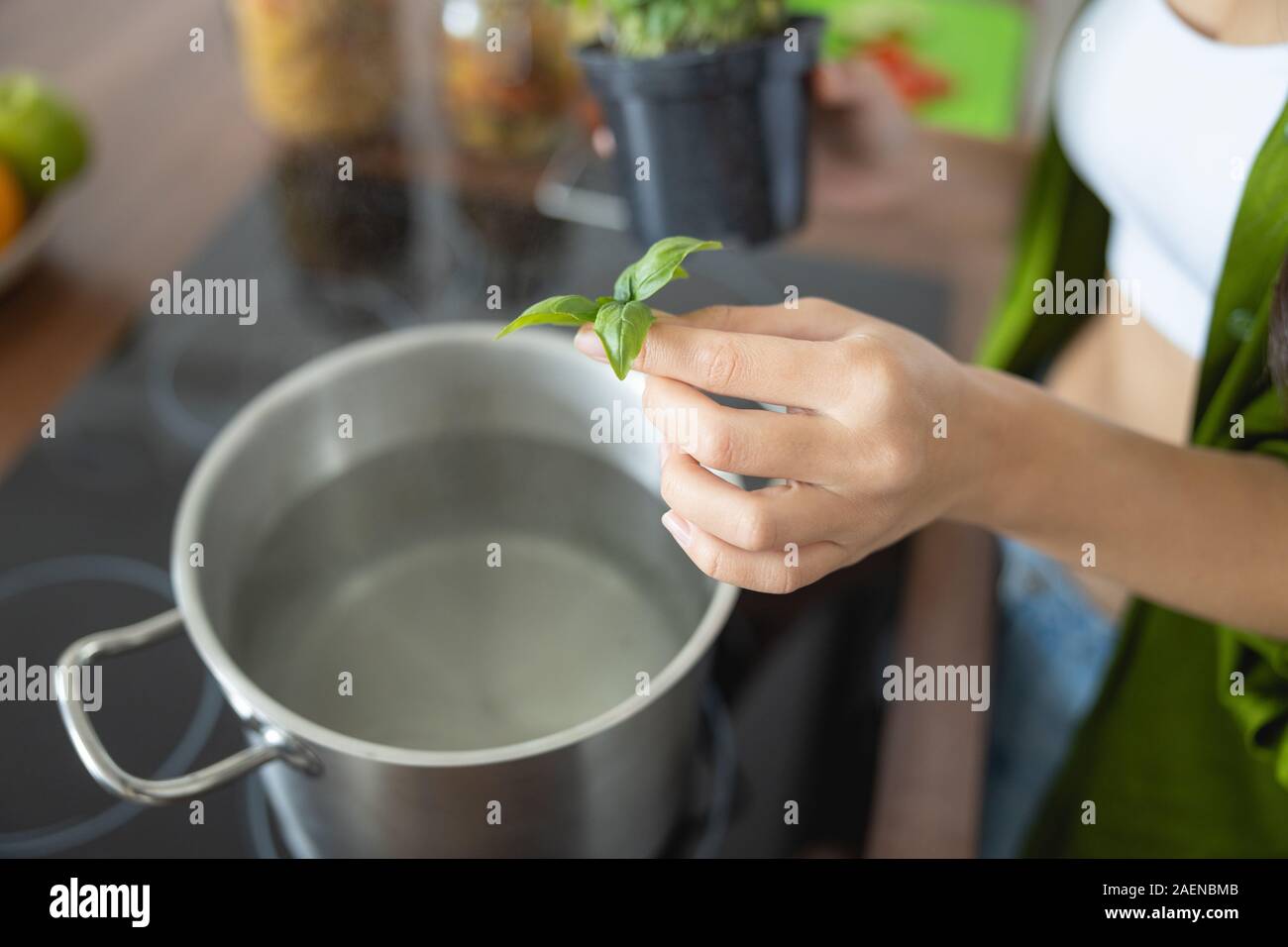 Woman cooking over pot hi-res stock photography and images - Alamy