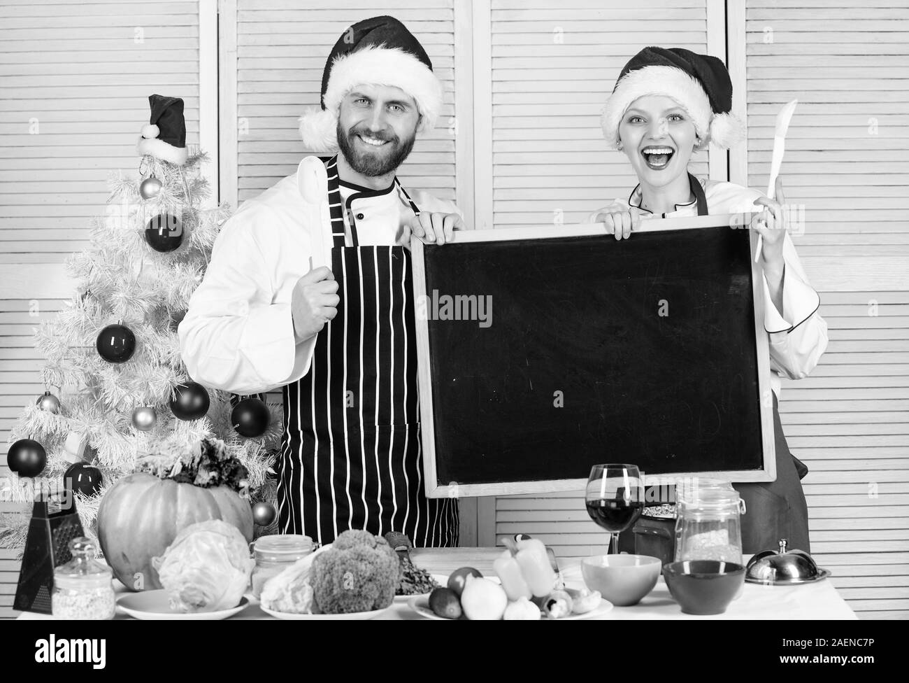 Man and woman chef santa hat near christmas tree hold blackboard copy ...