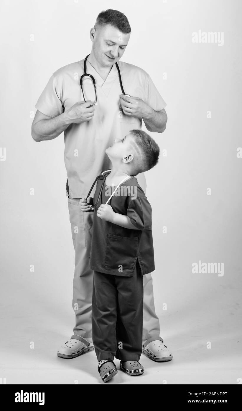 Cute kid play doctor game. Family doctor. Pediatrician concept. Father ...