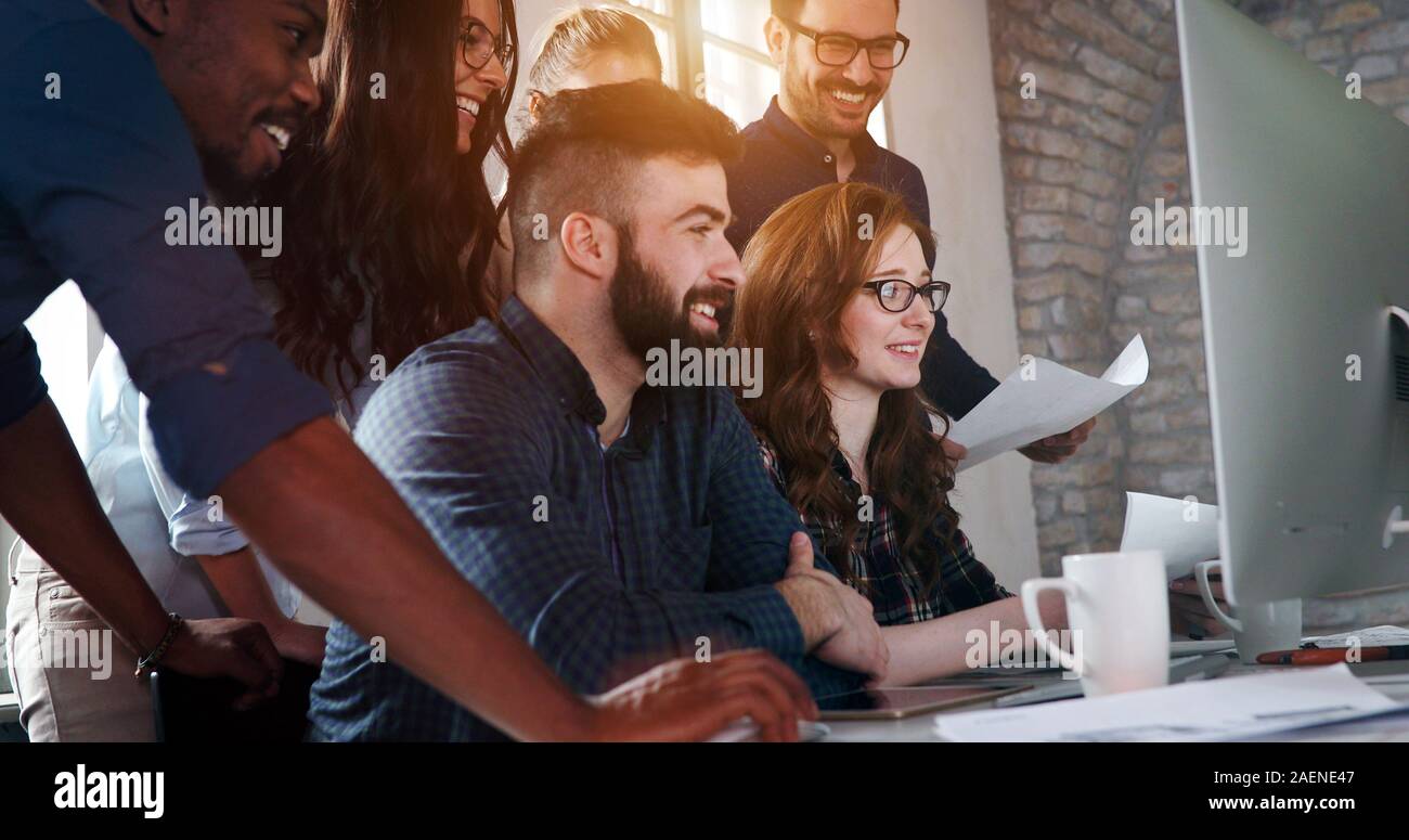 Group of young designers working as team Stock Photo - Alamy