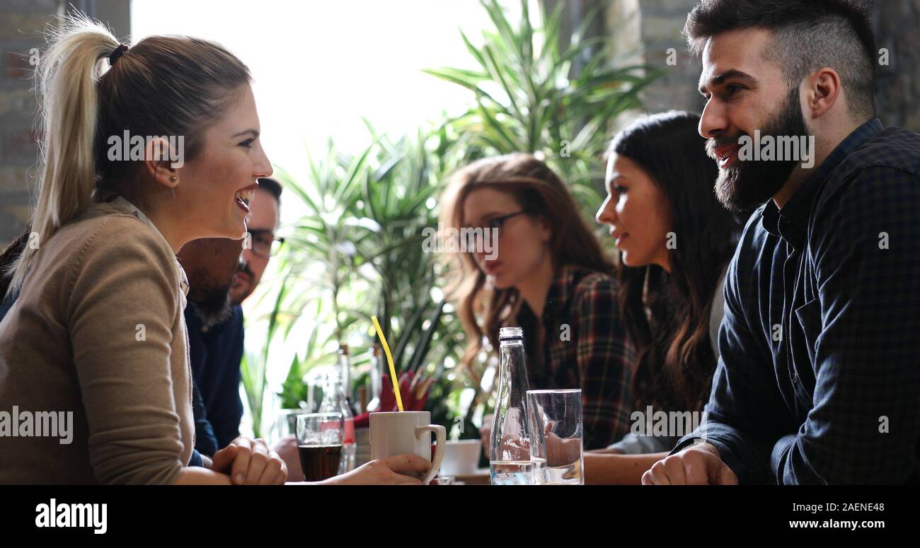Happy colleagues from work socializing in restaurant Stock Photo - Alamy
