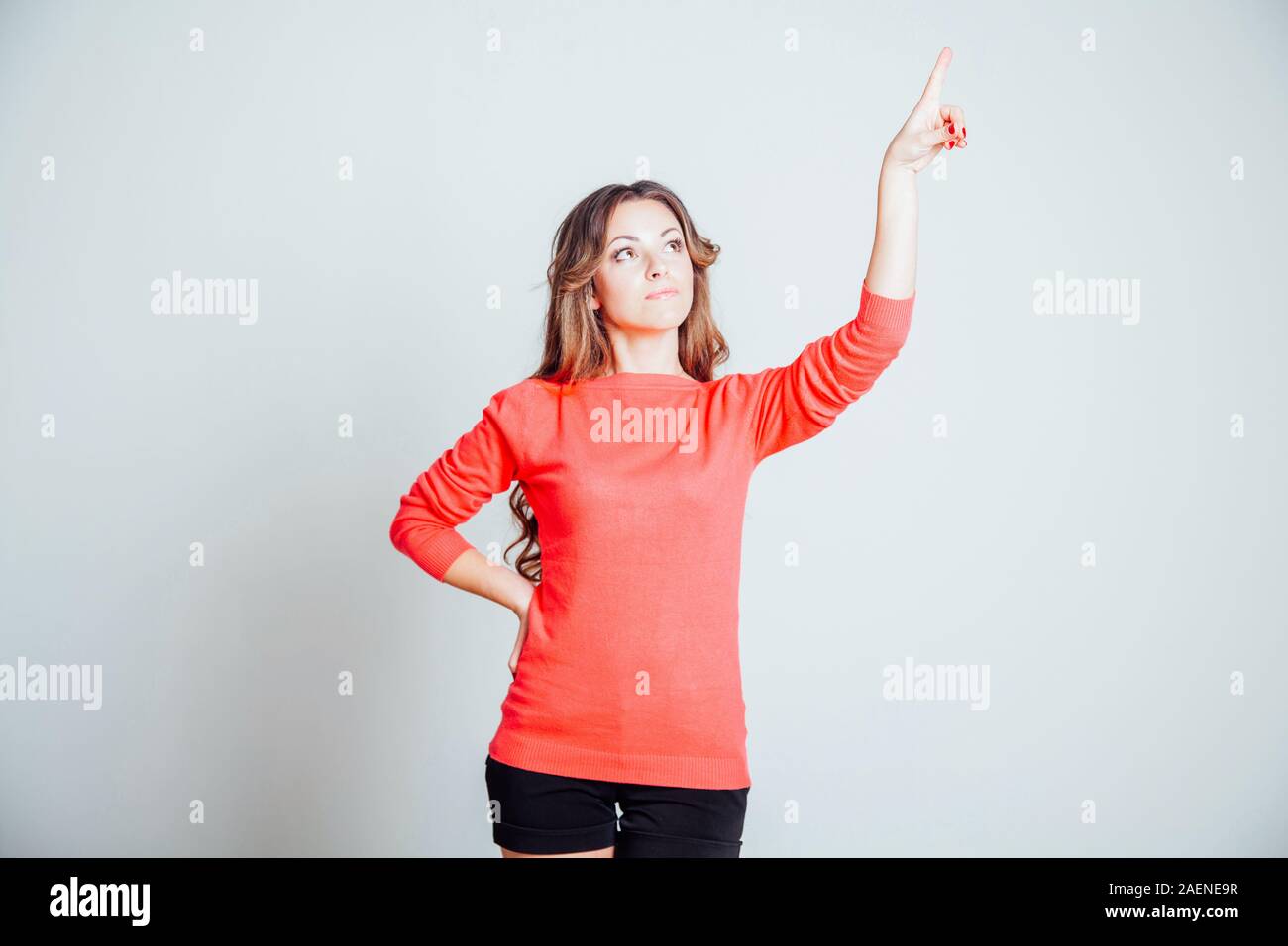 beautiful girl shows the direction of the hand Stock Photo - Alamy