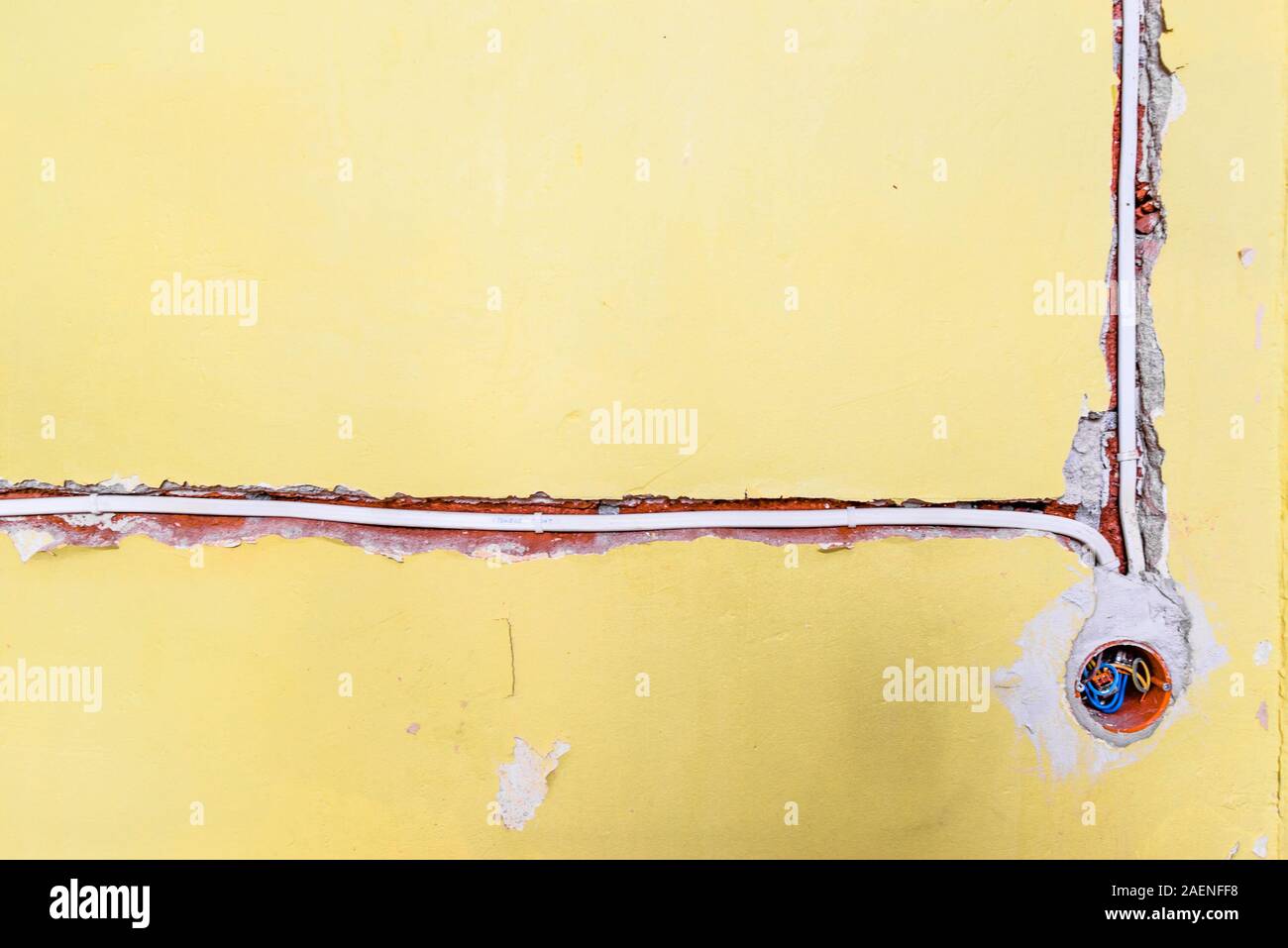 New electrical installation, socket and electrical cables on the wall ...