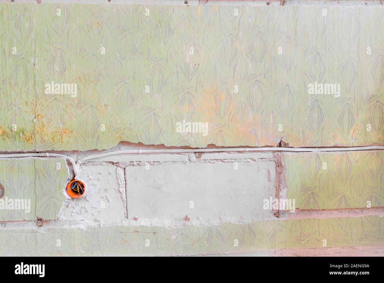 New electrical installation, socket and electrical cables on the wall ...