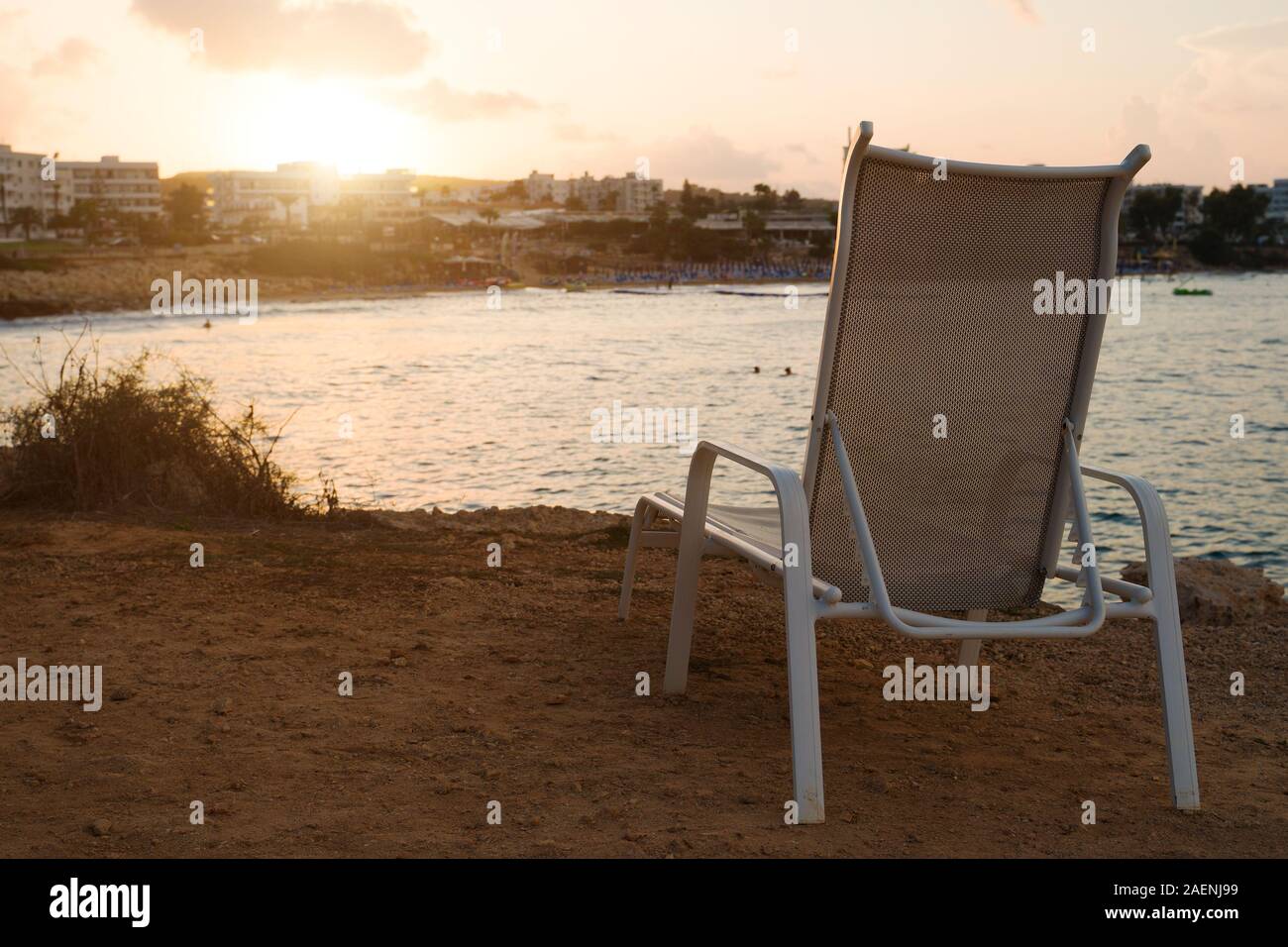 Sunbed in front of Fig Tree Beach in Protaras on sunset Stock Photo - Alamy
