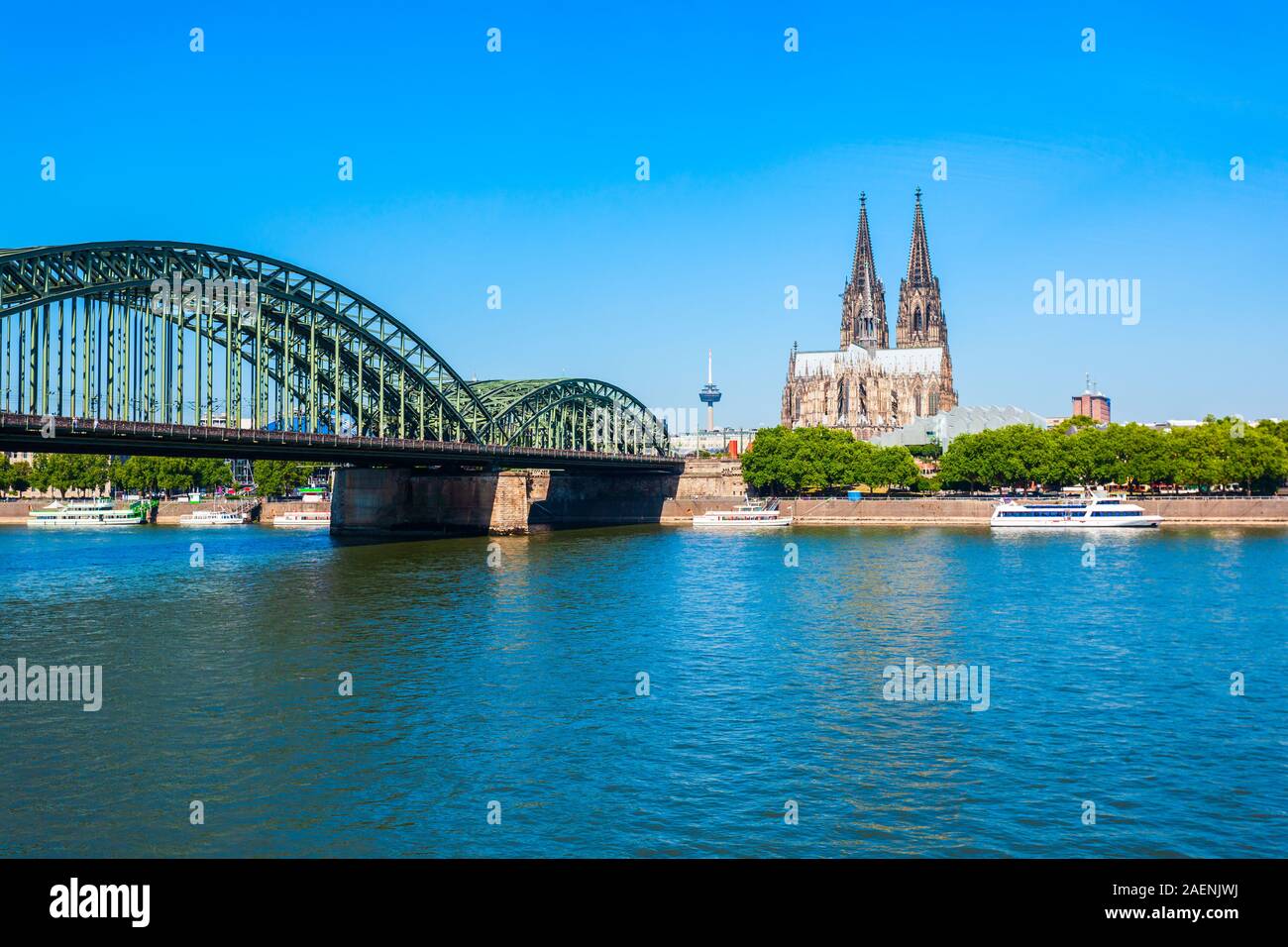 Cologne Cathedral and Hohenzollern Bridge through Rhine river in ...