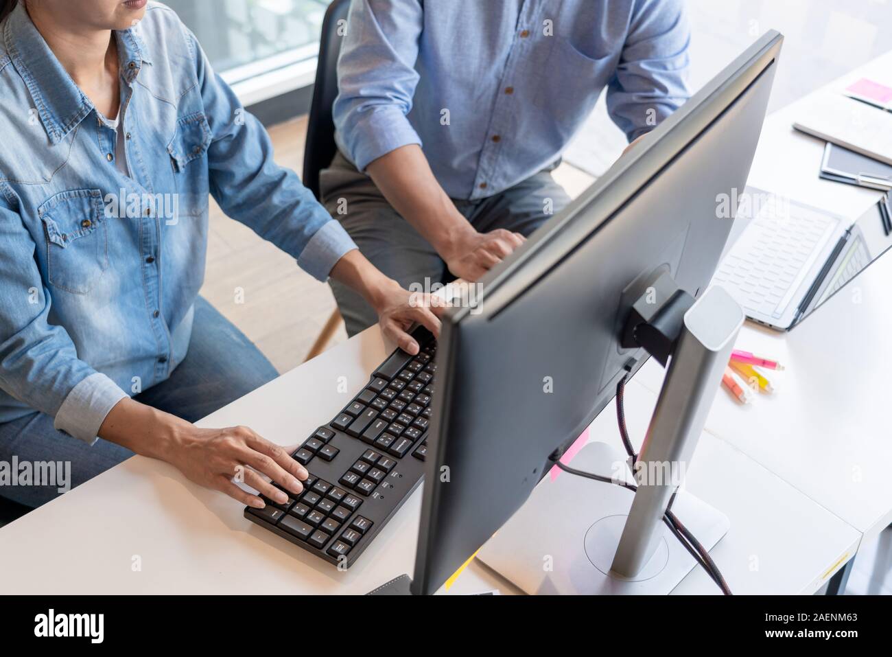 Young startup Programmers Sitting At Desks Working On Computers screen ...