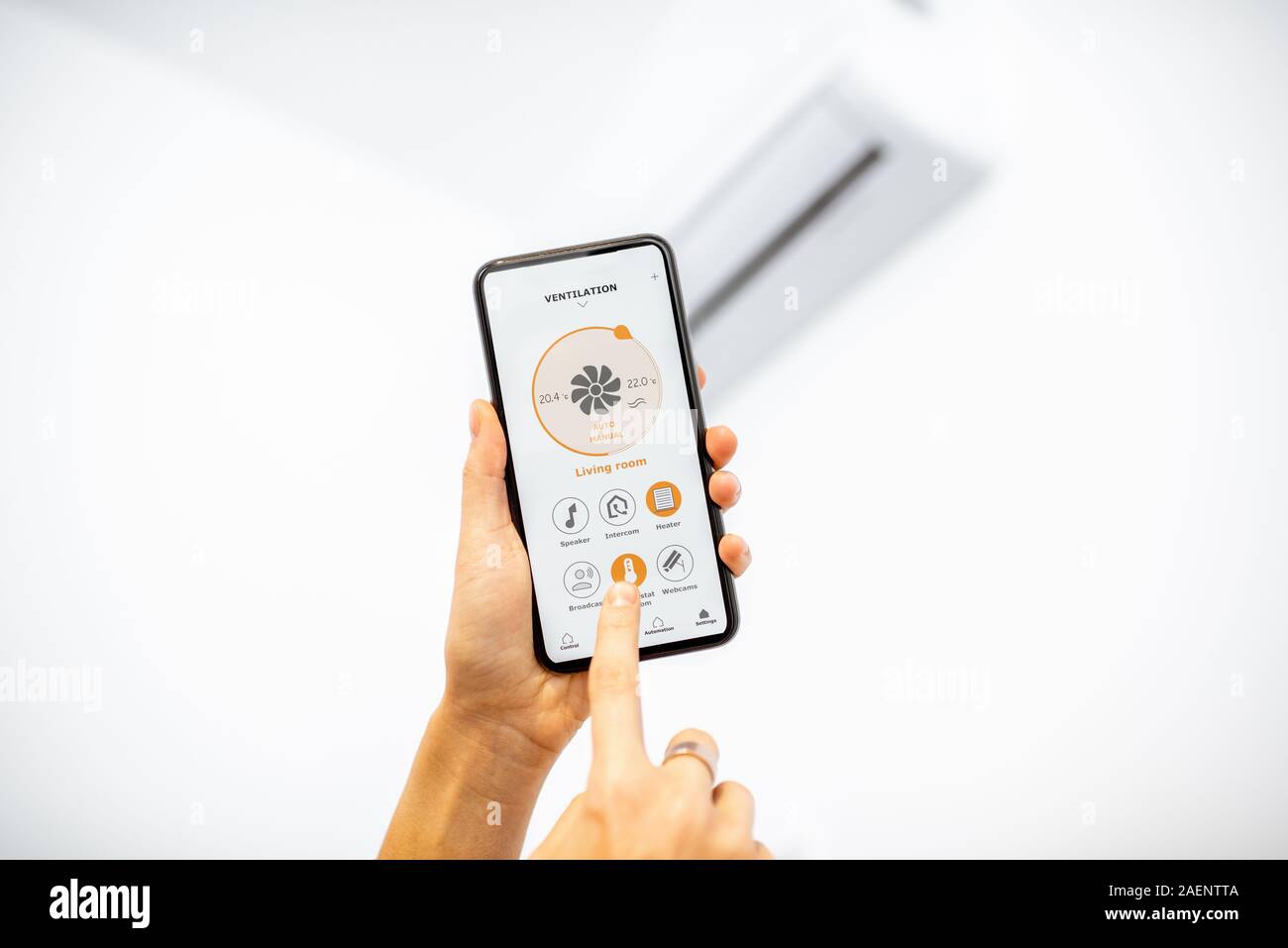 Controlling home conditioning with a smart phone, close-up. Concept of ...