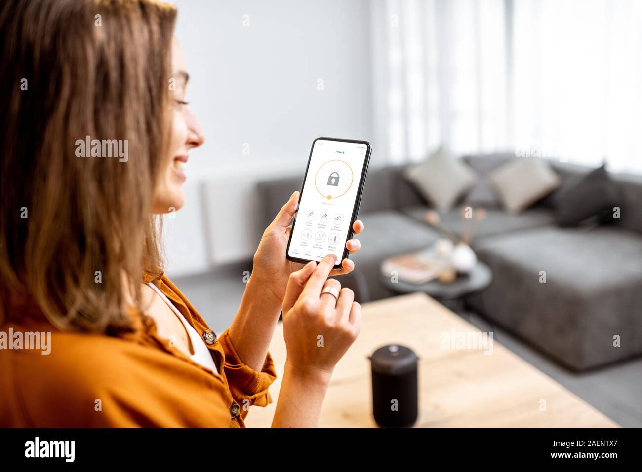 Young woman holding smart phone with launched security application at ...