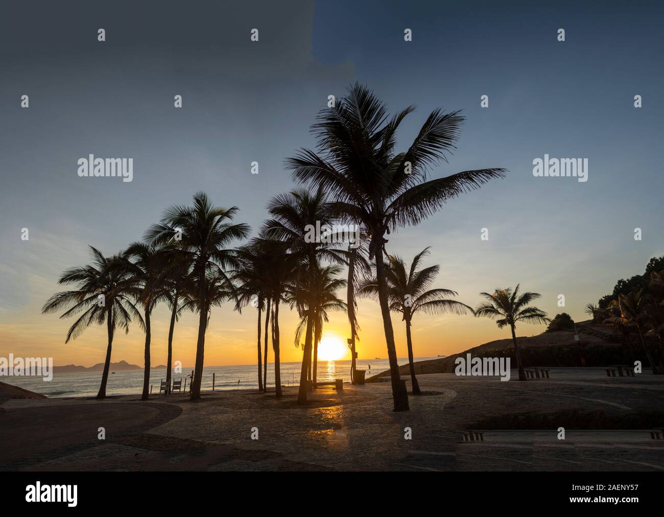 Sunrise on the Arpoador boulevard with the Devils beach and silhouetted ...