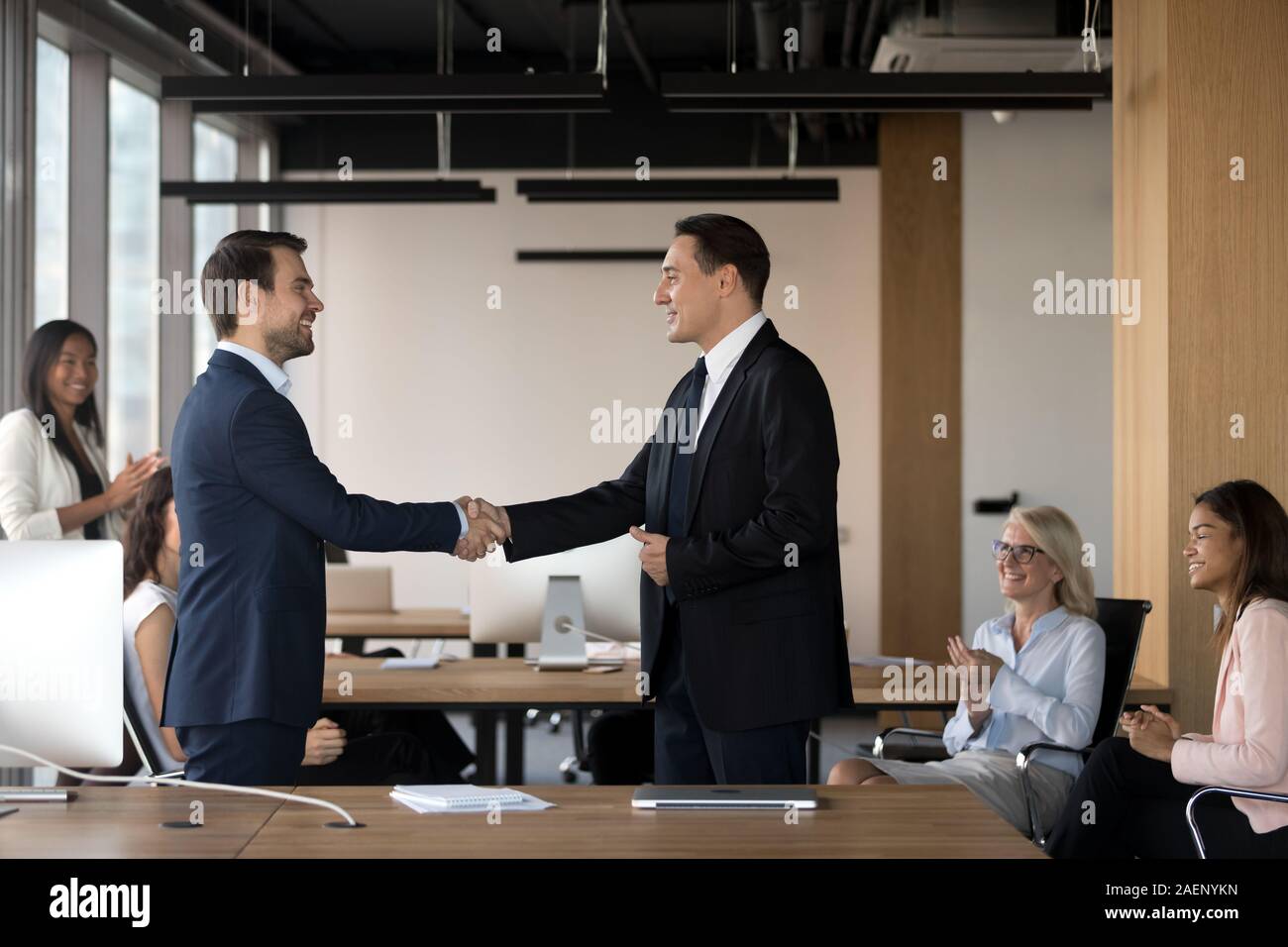 Executive manager shaking hand of successful employee at meeting Stock ...