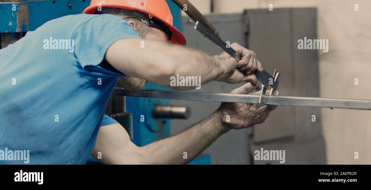 Workers using a verniercaliper measurement of rebar. Construction ...