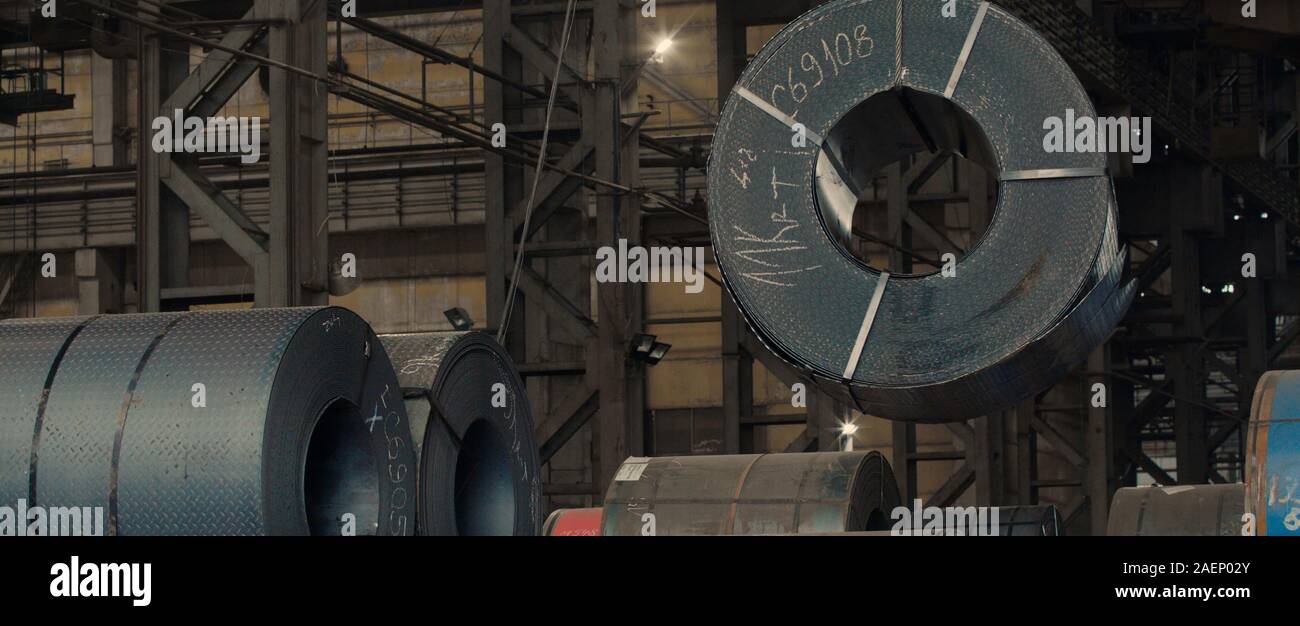 Industrial tiered rack with sheet metal rolls for metal profile forming ...