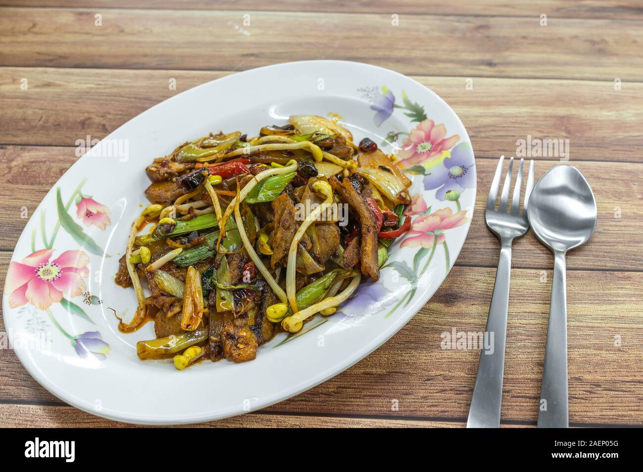 Stir-fry spicy sliced beef with bean sprouts, dried chillies and spring ...