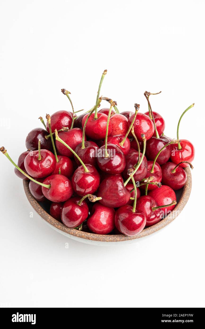 A bunch of fresh red cherries arranged and fitted in small round ...