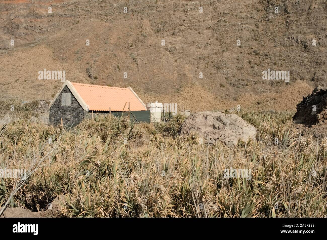 Isolated black stone house in the countryside near a trash bin (Madeira ...