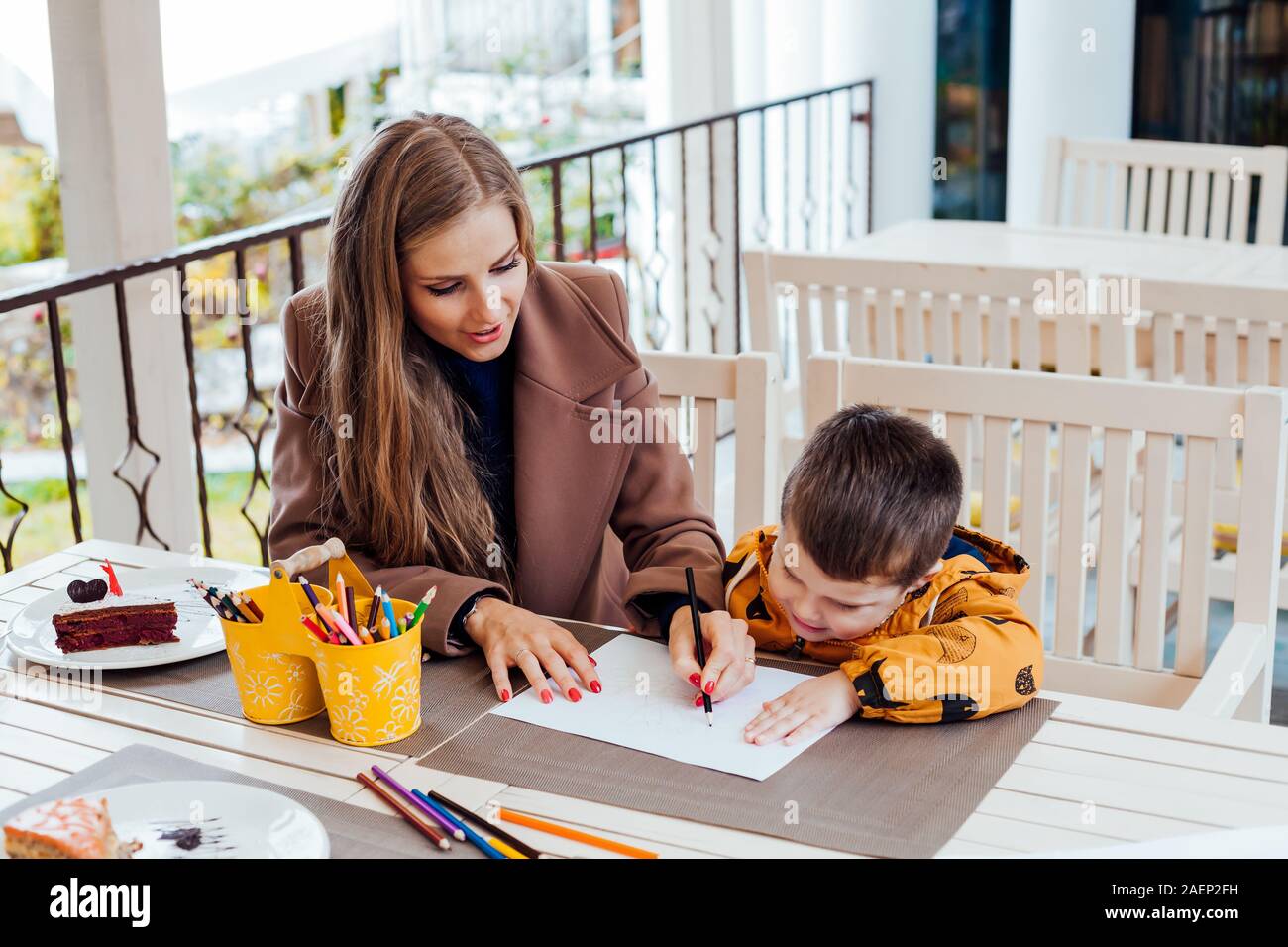 mom helps son to draw drawing colored pencils Stock Photo - Alamy