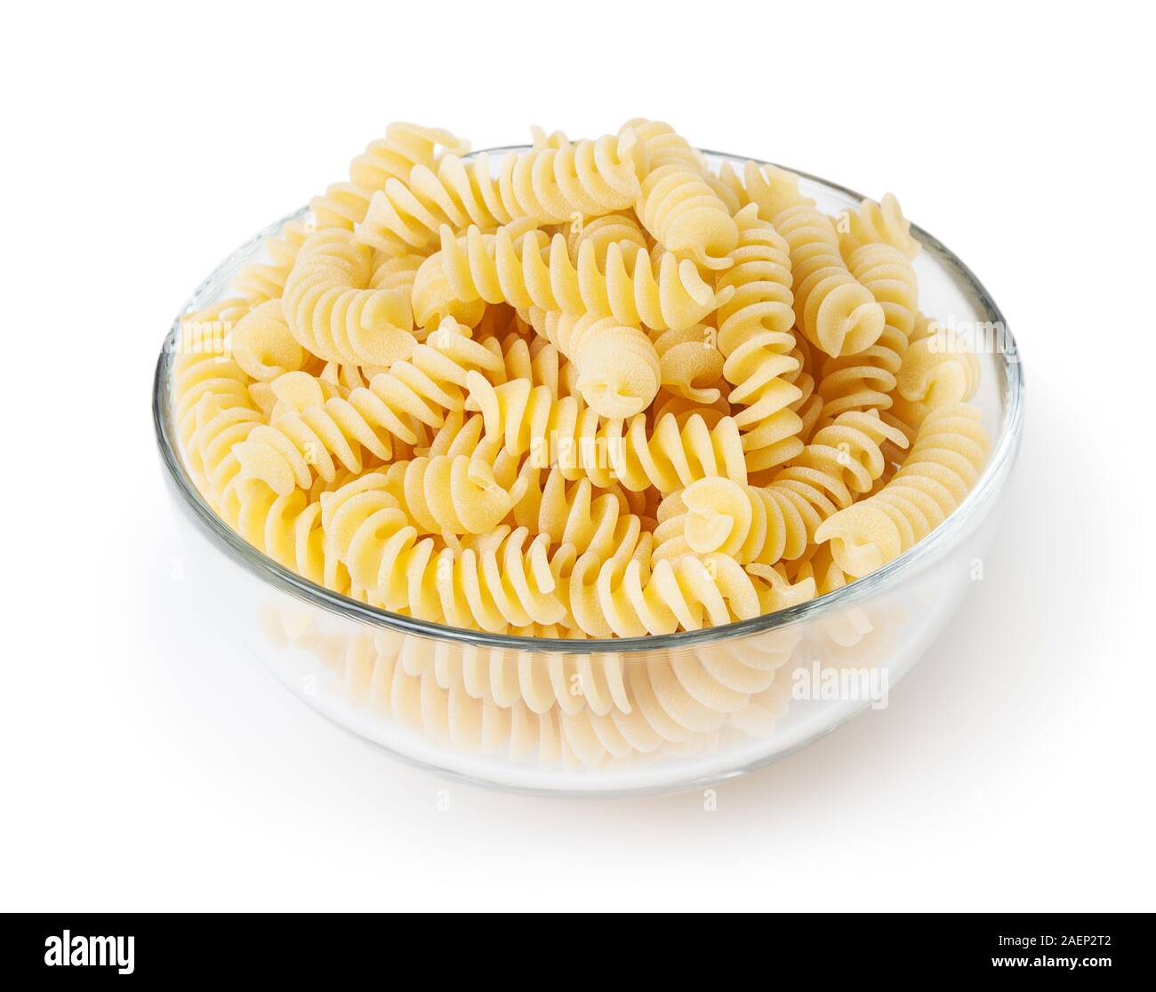 Uncooked fusilli pasta in glass bowl isolated on white background with ...