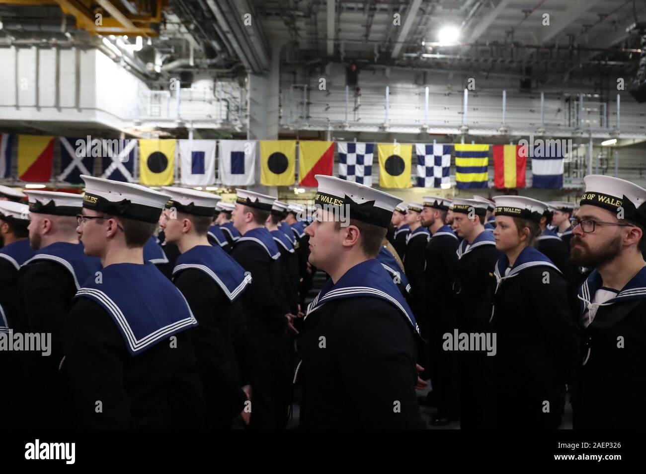 Members of the ship's company during the commissioning ceremony of the ...
