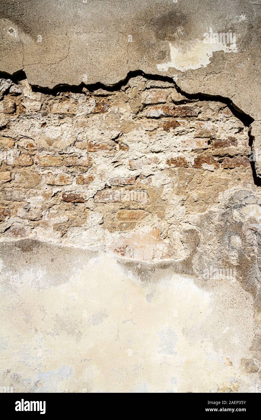 Old beige brick and plaster wall texture background. Distressed wall ...
