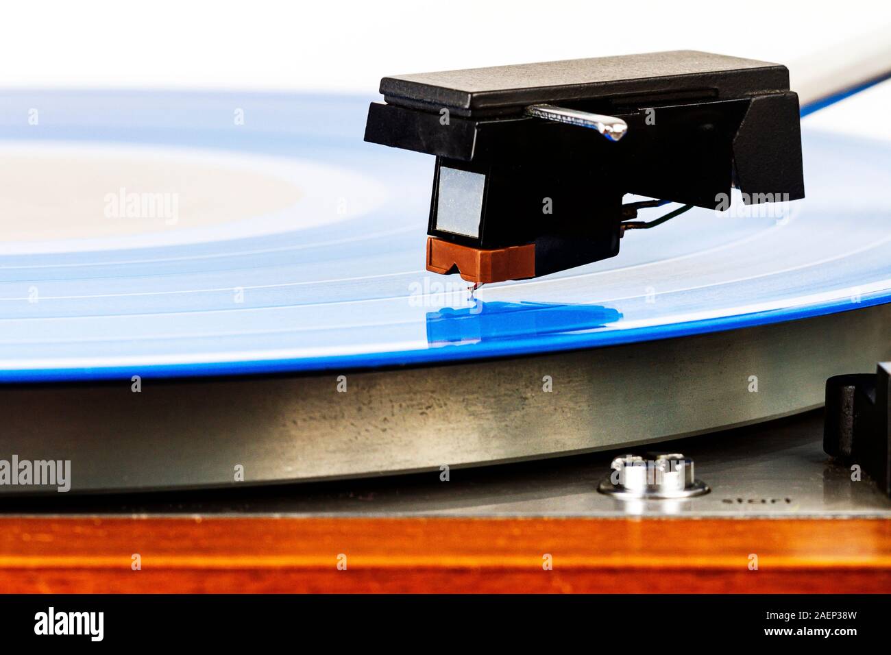 Close up of turntable cartridge on a vinyl record. Turntable playing ...