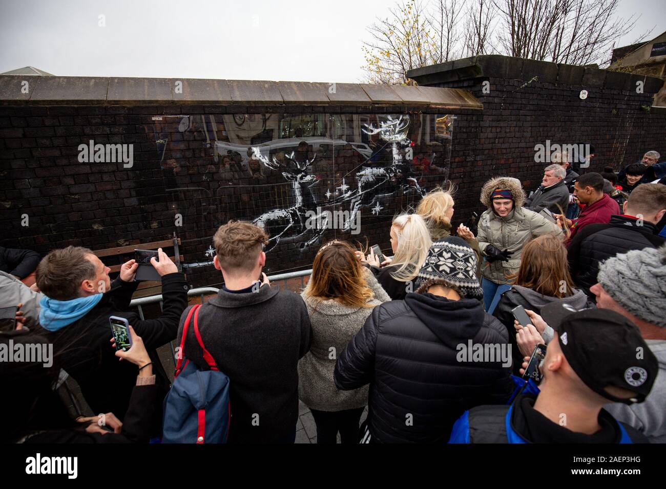 Workmen use perspex sheeting to protect a new Banksy artwork in ...