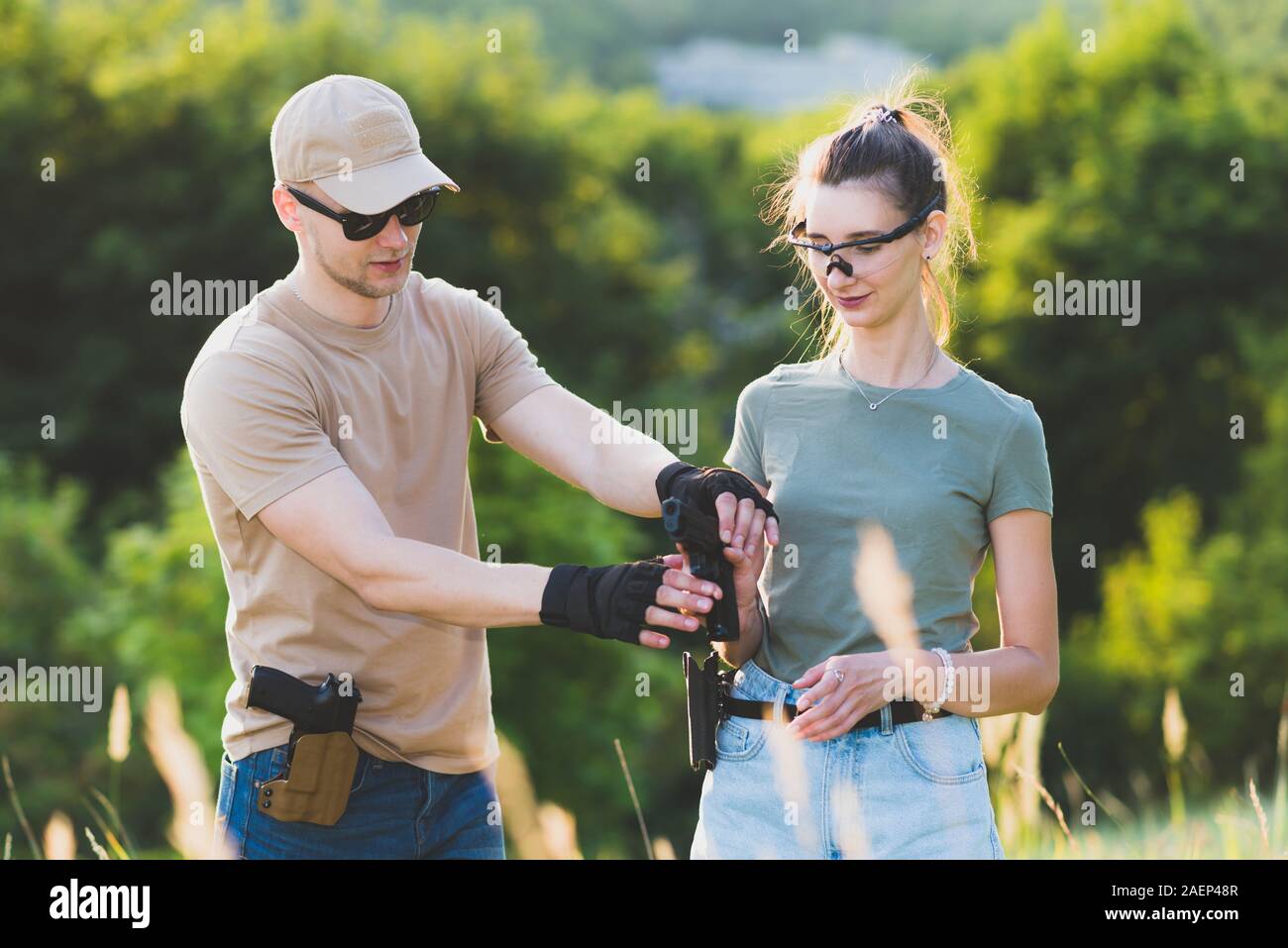 The shooting instructor teaches the backslider how to handle a weapon ...