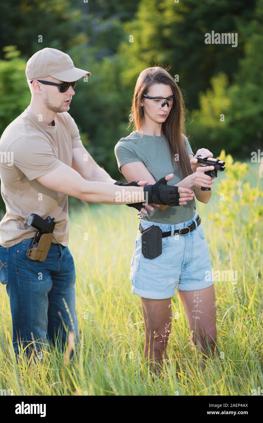 The shooting instructor teaches the backslider how to handle a weapon ...