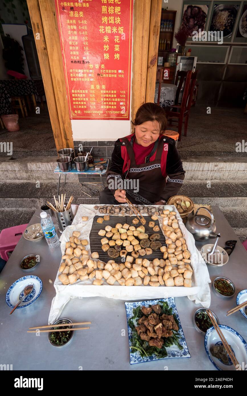 March 7, 2019: Vendor sells some food in a restaurant of Jianshui ...