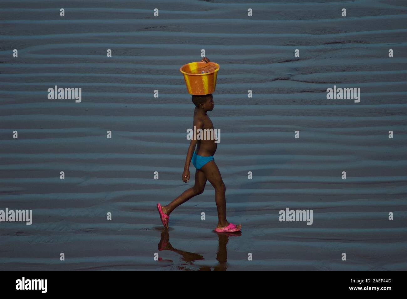 Boy with bucket Stock Photo - Alamy