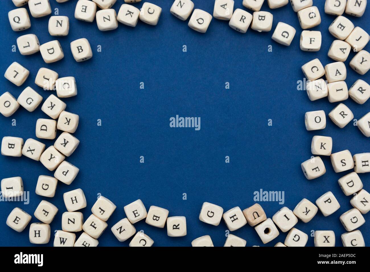 Wooden letter blocks over blue background, flat lay Stock Photo - Alamy