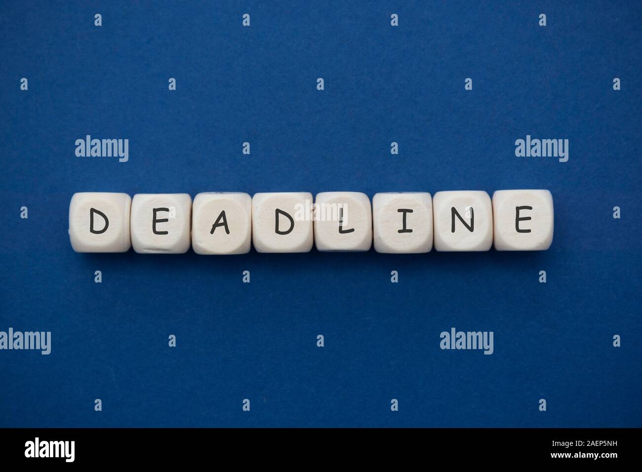 Deadline word on wood blocks over blue background with copy space Stock ...