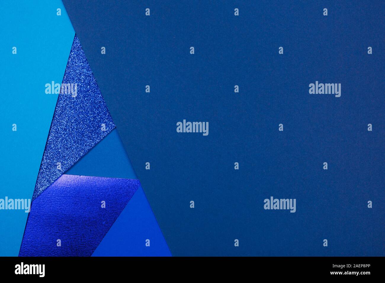 Divided in several parts blue paper background with metallic elemments ...