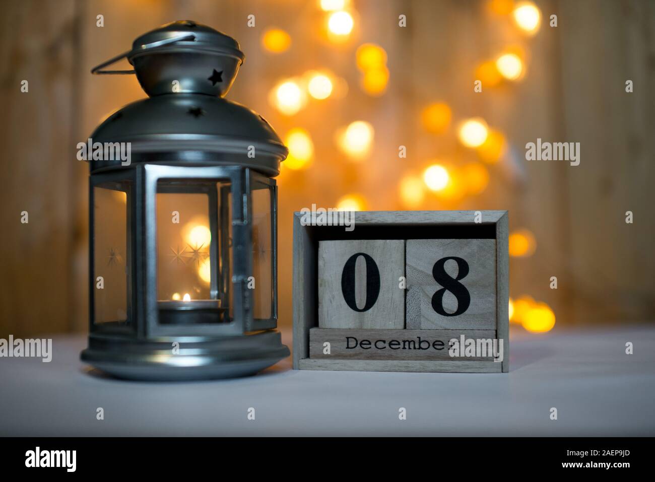 Cube wooden calendar showing date on 8th December with advent lantern ...