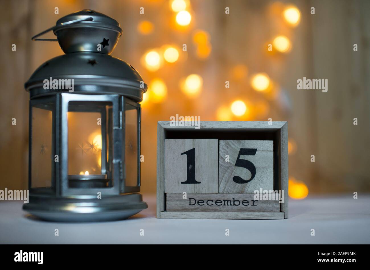 Cube wooden calendar showing date on 15th December with advent lantern ...