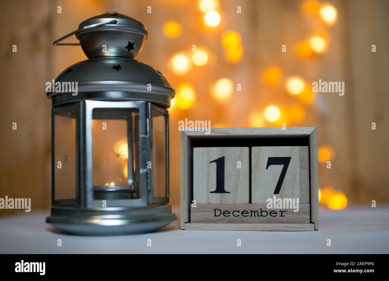 Cube wooden calendar showing date on 17th December with advent lantern ...