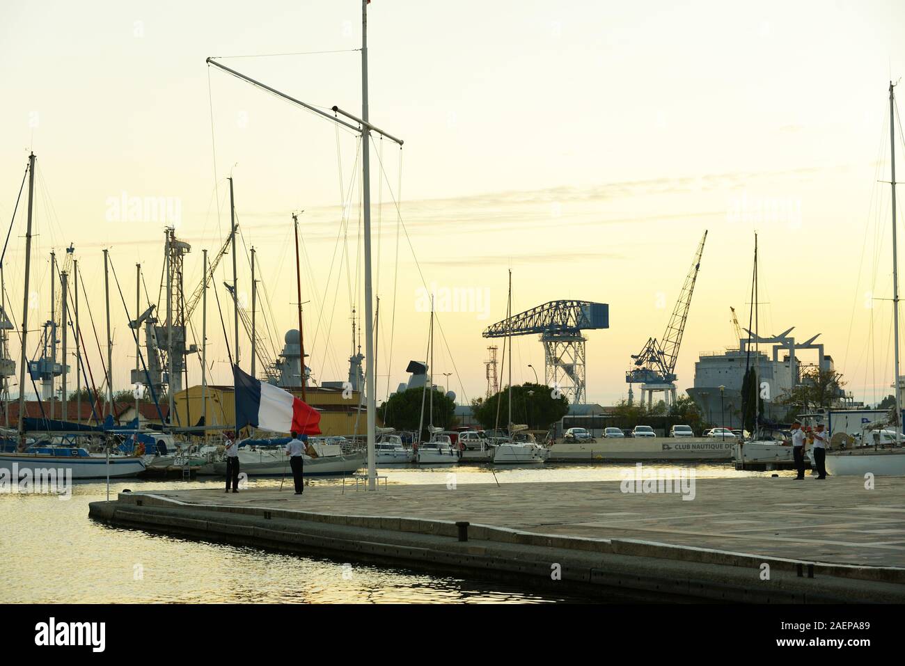 Descent of the national flag at sunset at the naval base of Toulon Var ...