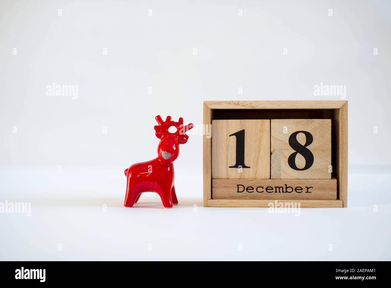 Cube wooden calendar showing date on 18th December with ceramic ...
