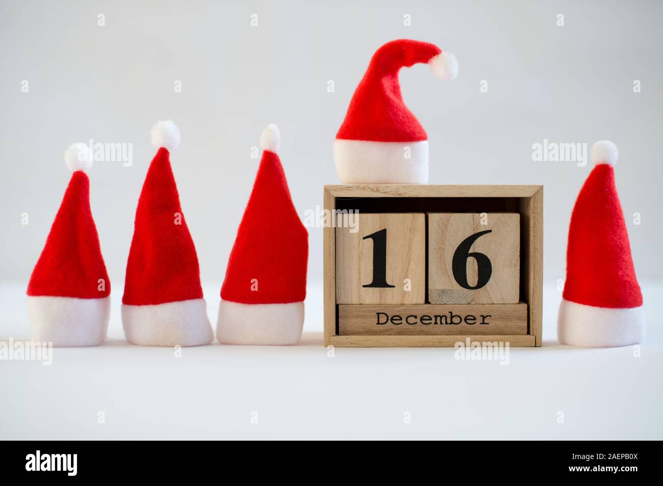 Cube wooden calendar showing date on 16th December with small Santa ...