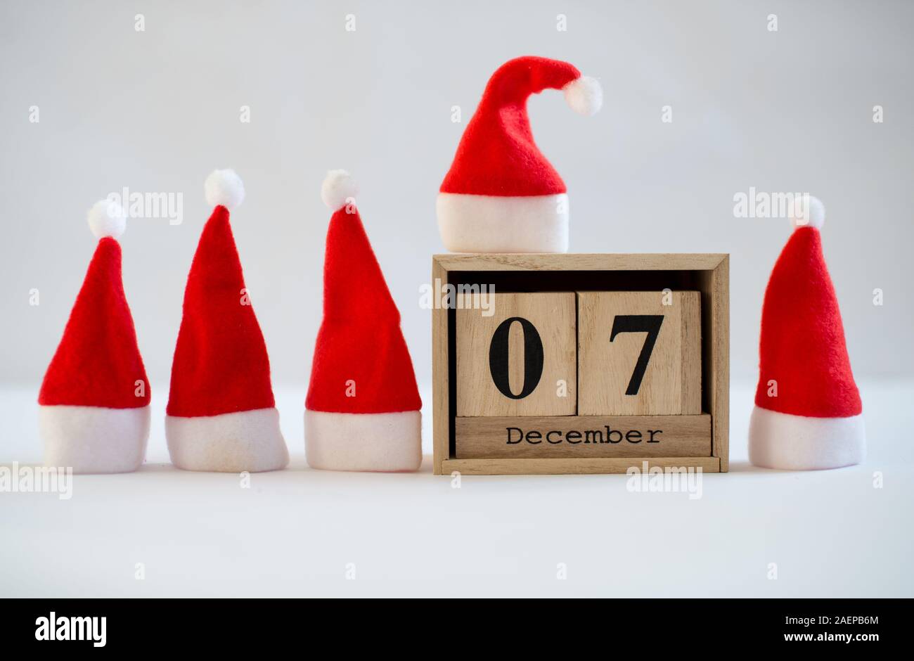 Cube wooden calendar showing date on 7th December with small Santa hats ...