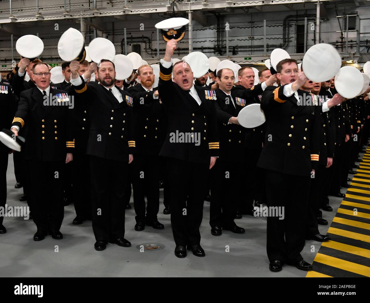 Members of the ship's company during the commissioning ceremony of the ...