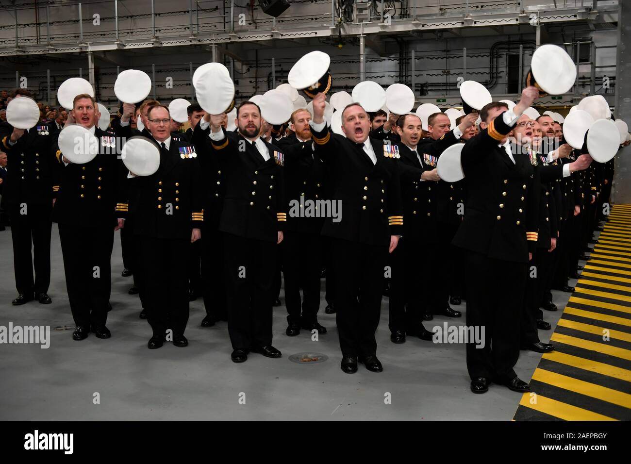 Members of the ship's company during the commissioning ceremony of the ...