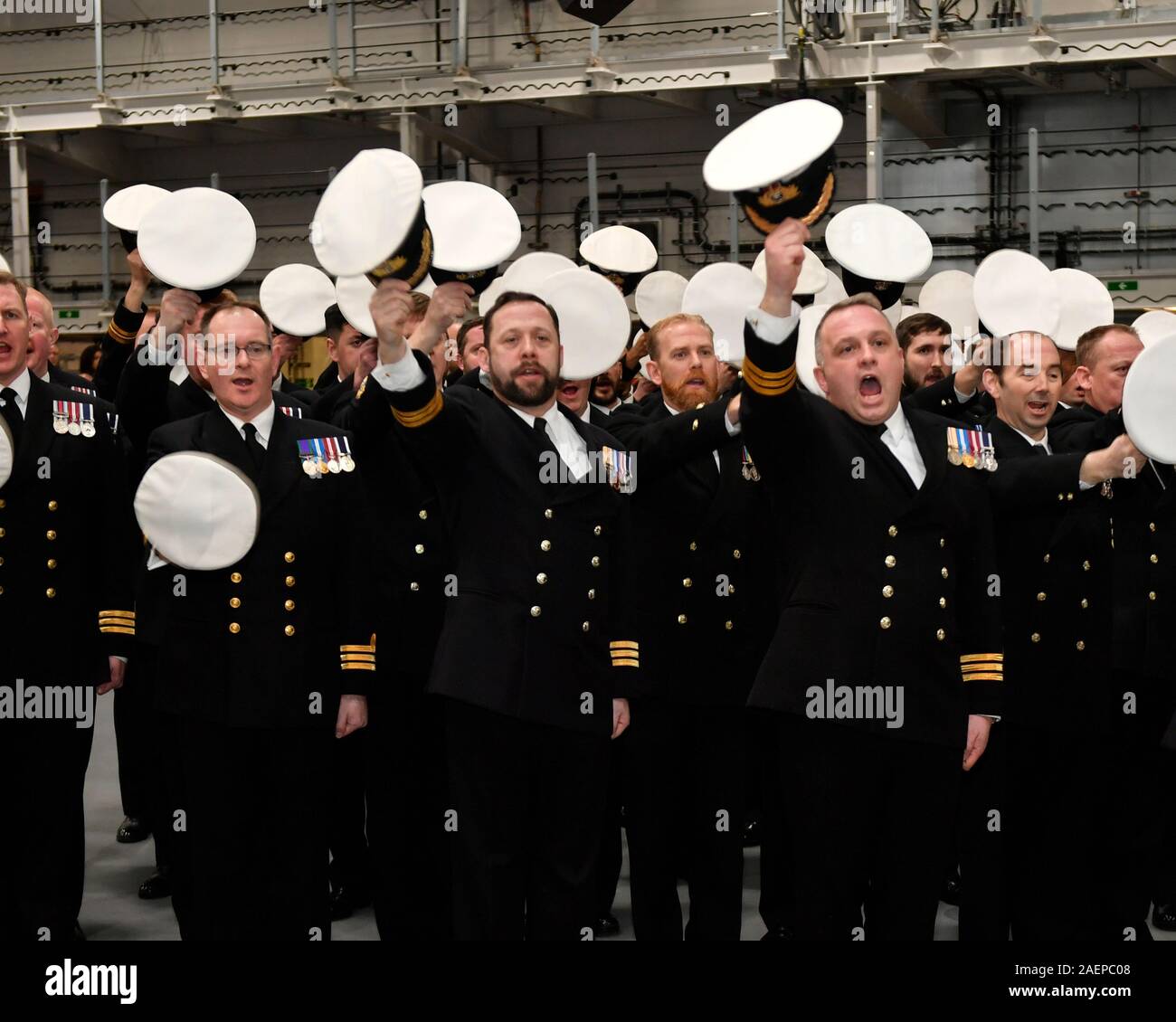 Members of the ship's company during the commissioning ceremony of the ...