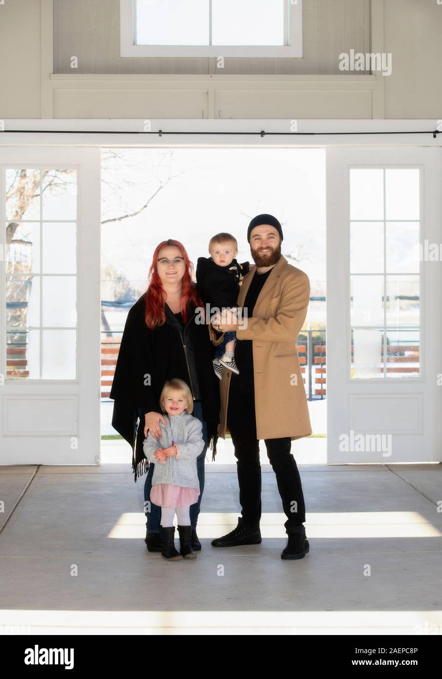 Millennial Family of Four with Two Young Children, Dressed in Warm ...