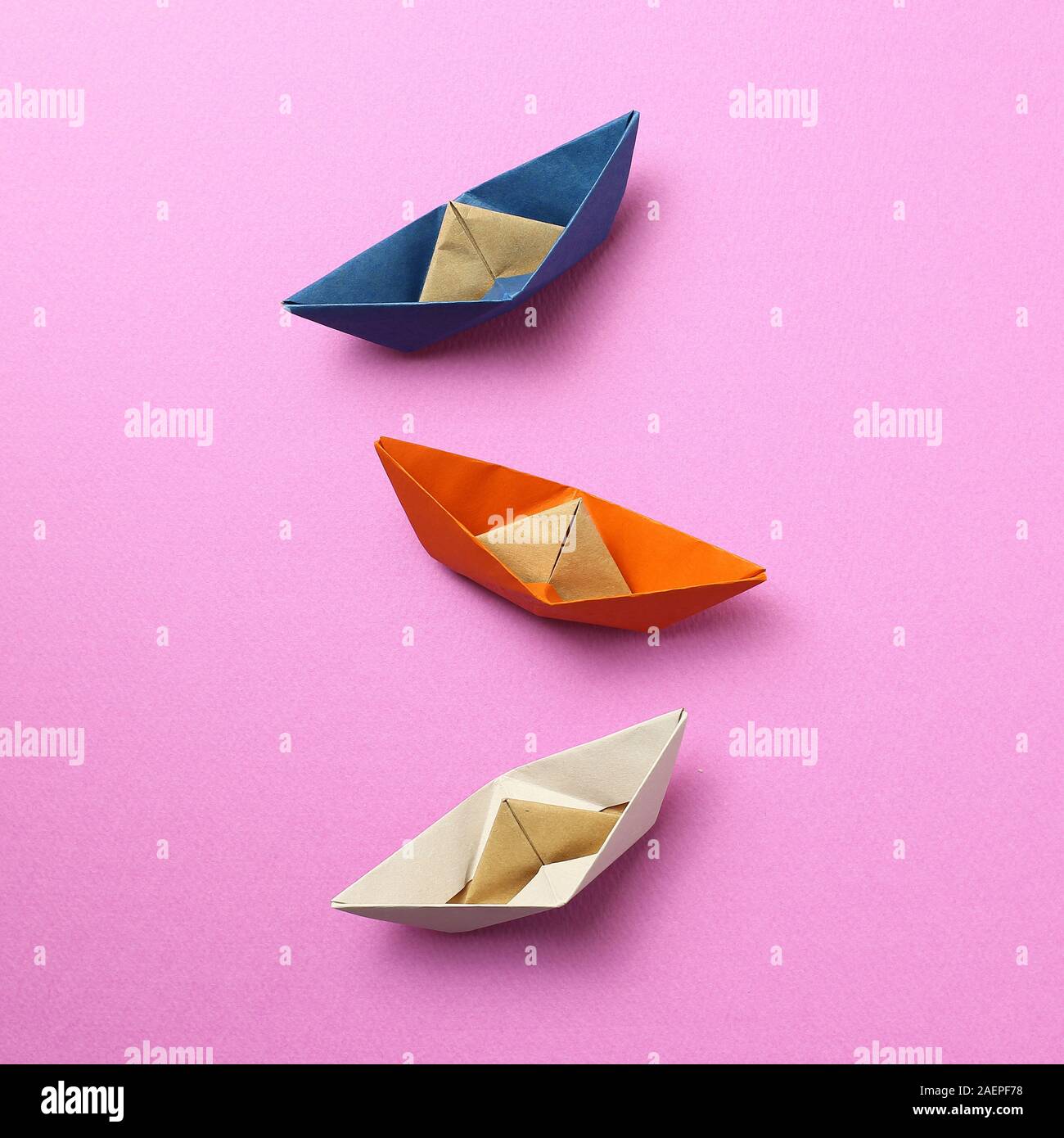 Paper ship on pink background Stock Photo - Alamy
