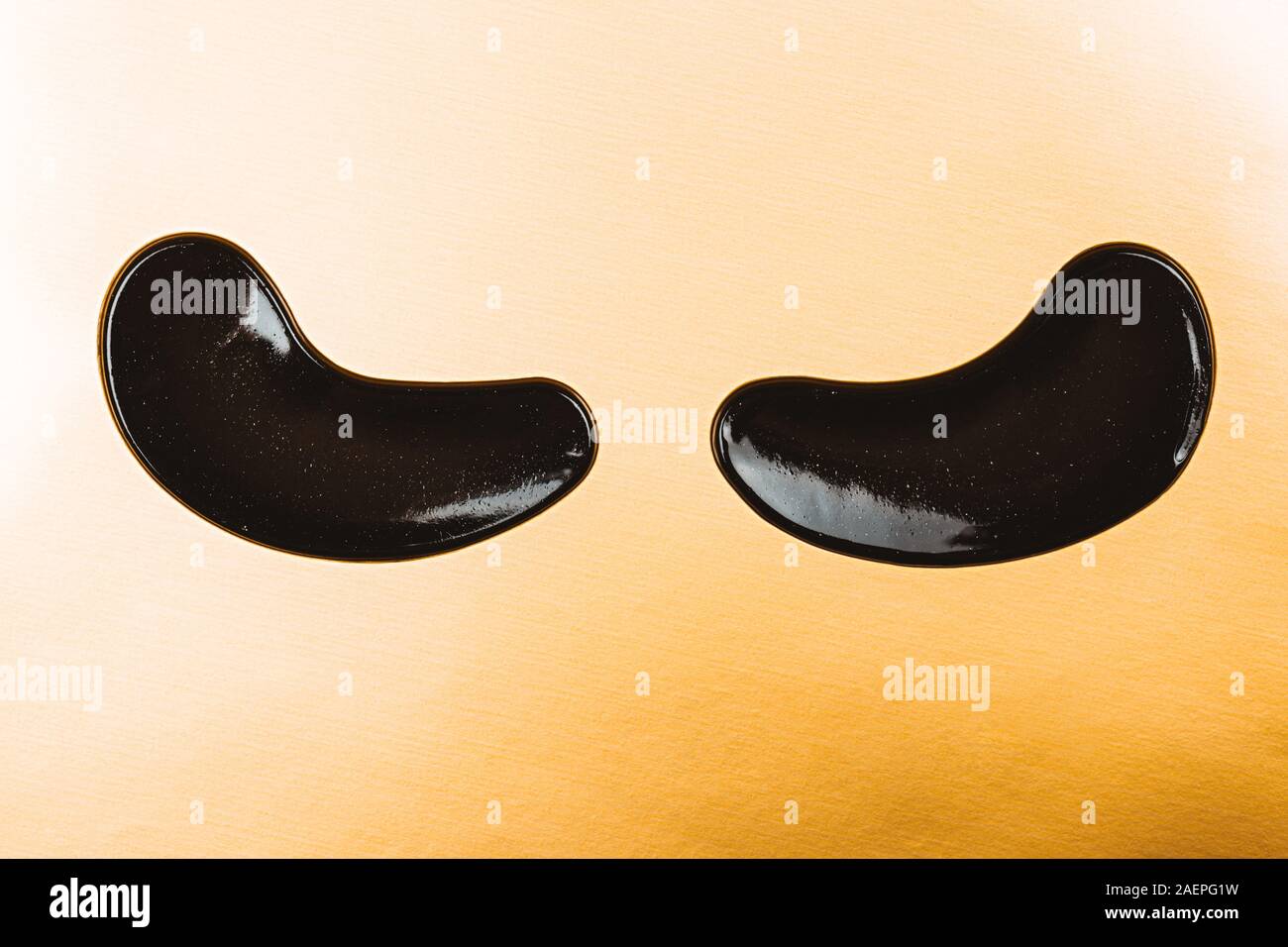 Black eye patches with collagen on bright background Stock Photo - Alamy