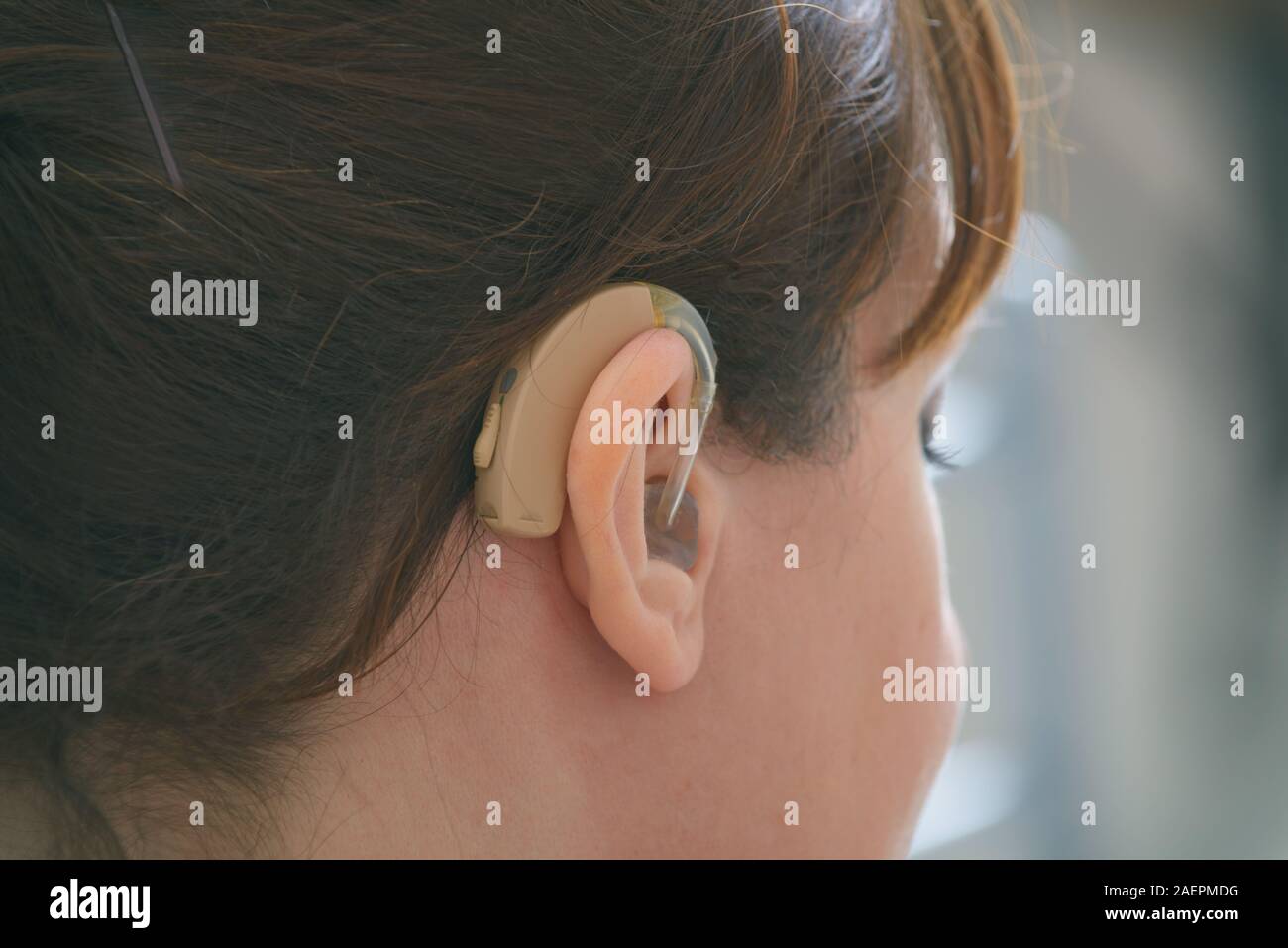 Smiling deaf woman wearing hearing aid Stock Photo - Alamy