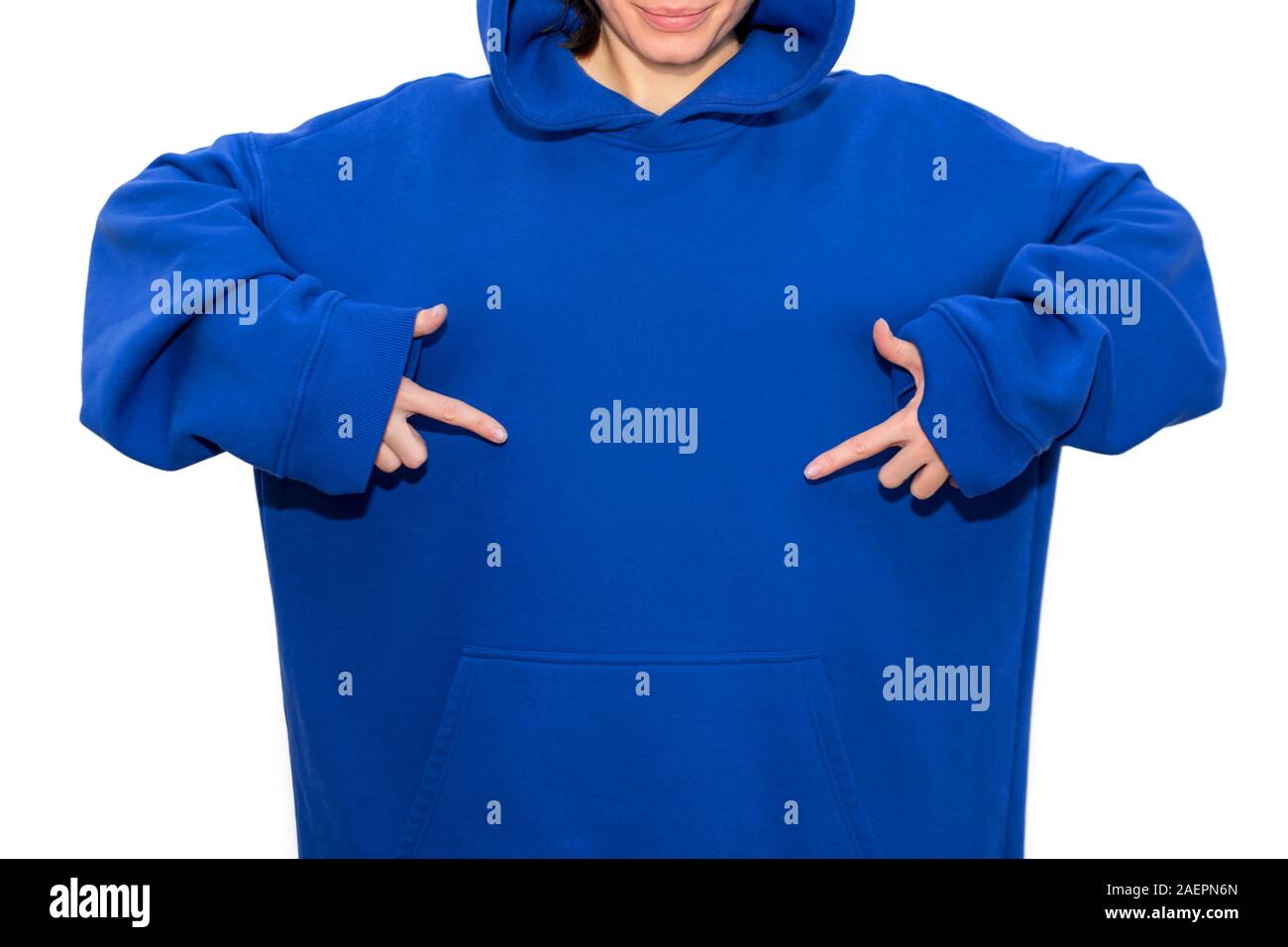 Young Hipster Girl Wearing Blue Hoodie And Pointing Fingers With Space
