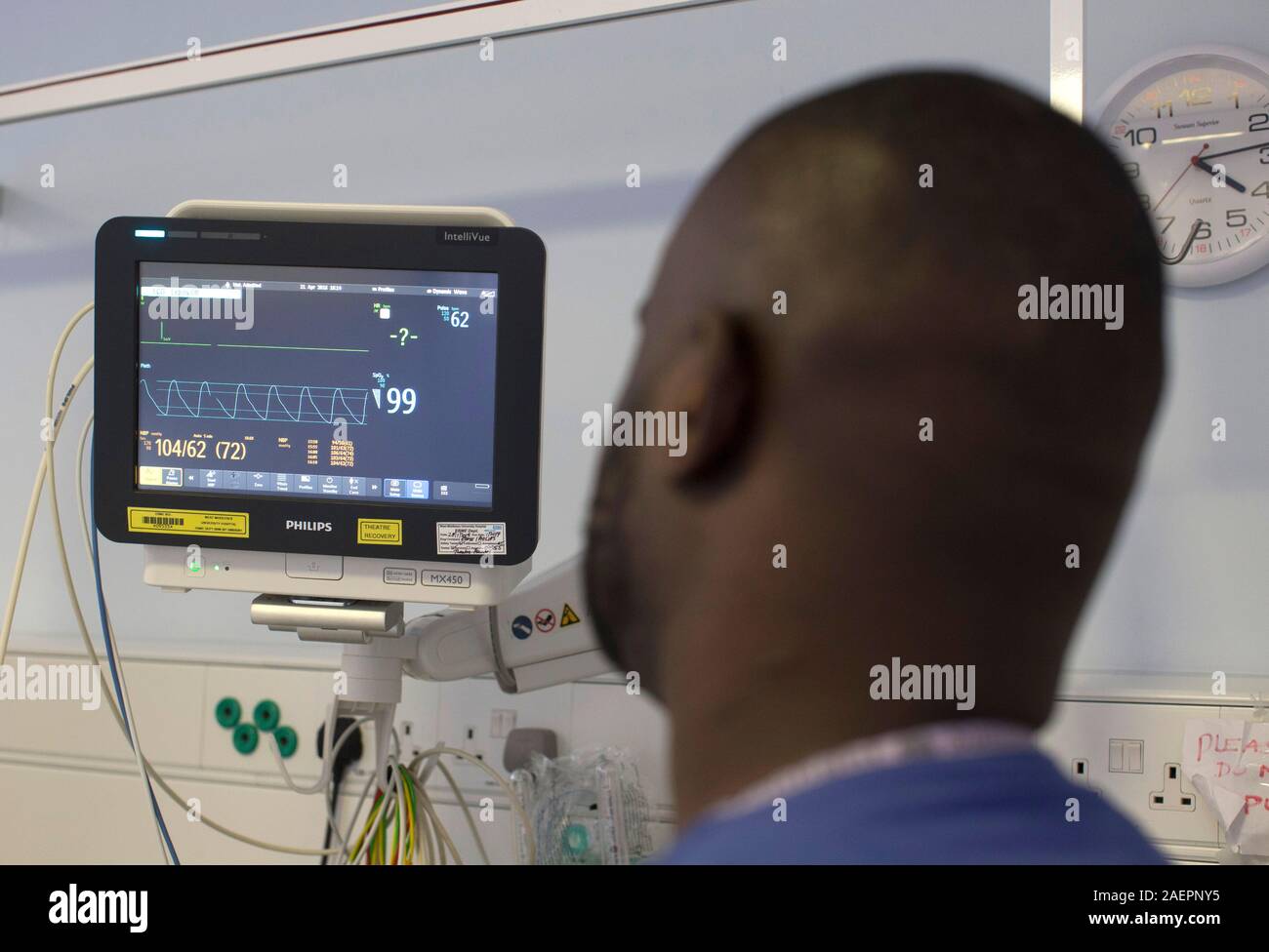 An Anaesthetist in a hospital operating theatre monitoring the progress ...