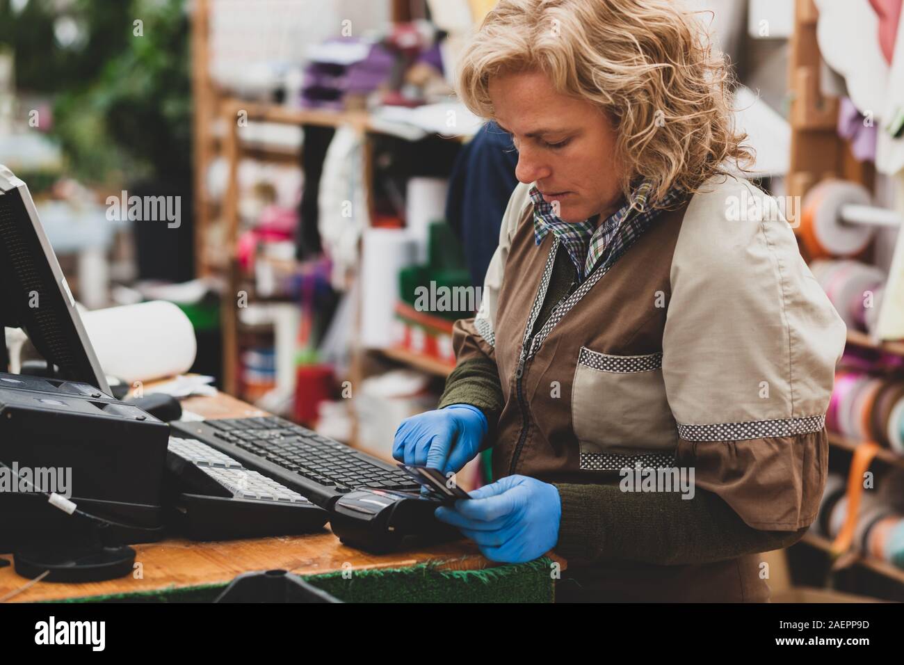 Florist with professional clothing in a nursery. Concept of electronic ...